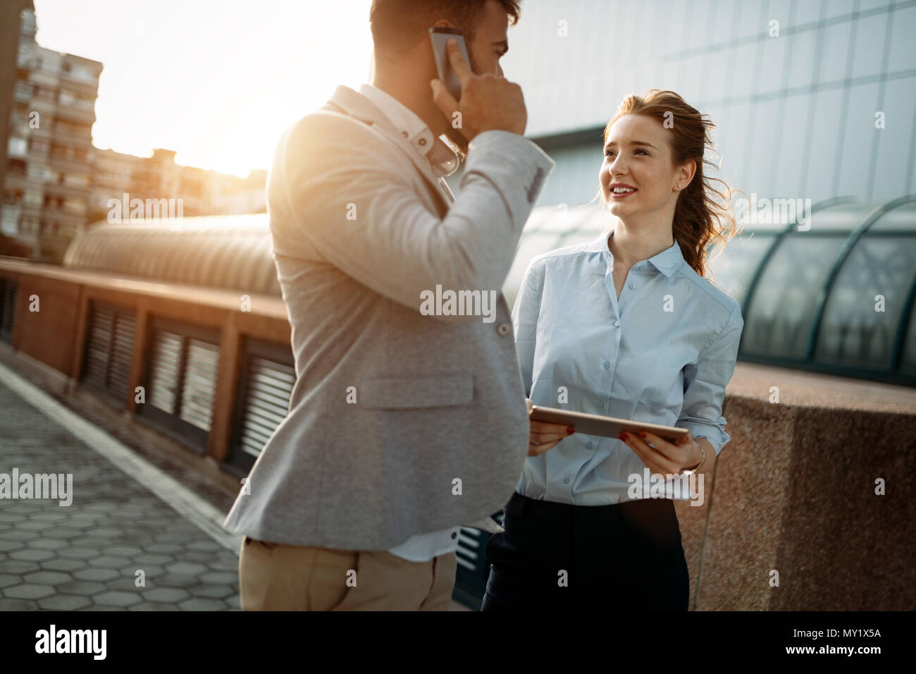 Business people walking and talking outdoor Stock Photo - Alamy