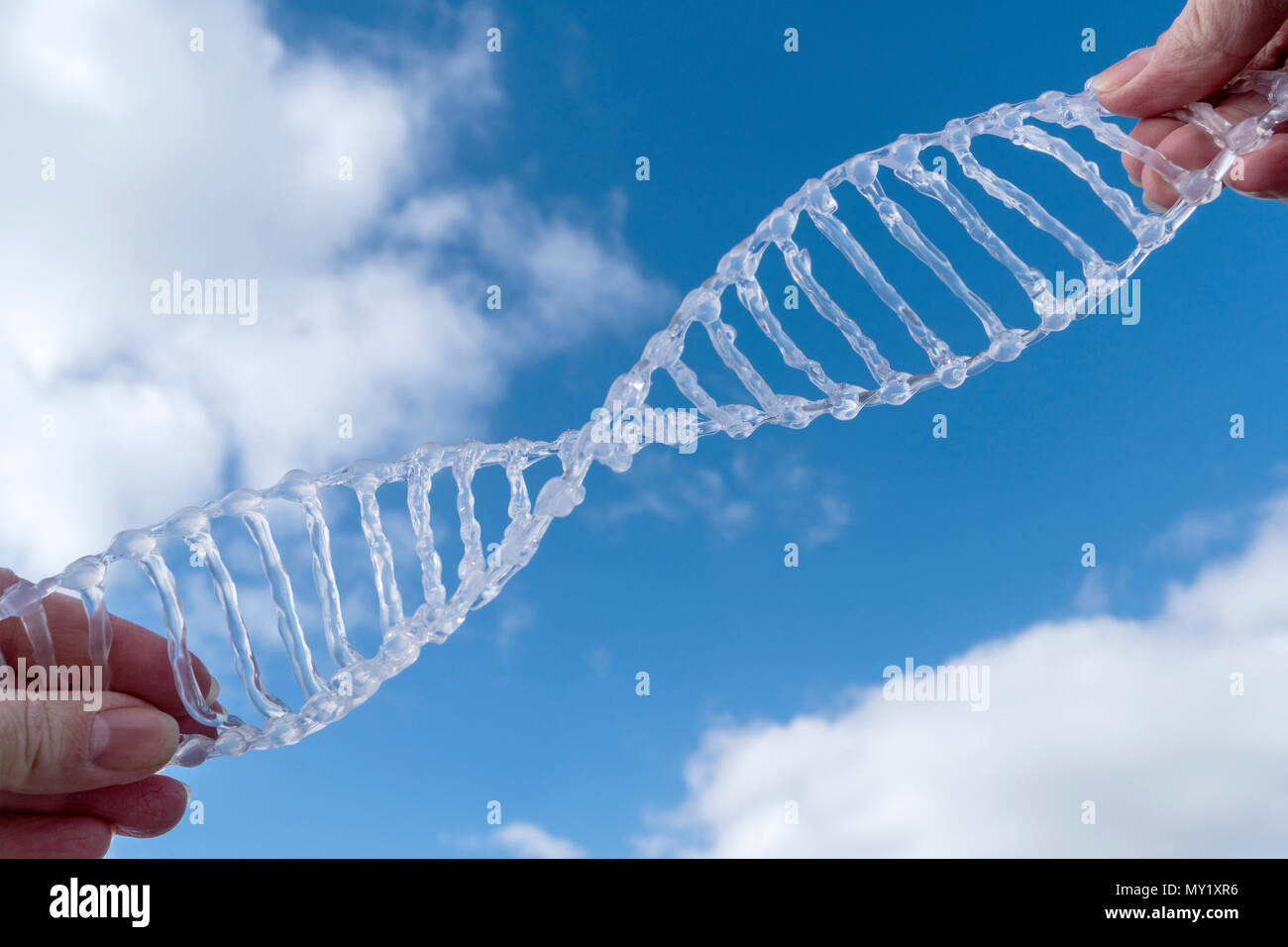 spiral dna against the blue sky with clouds Stock Photo - Alamy