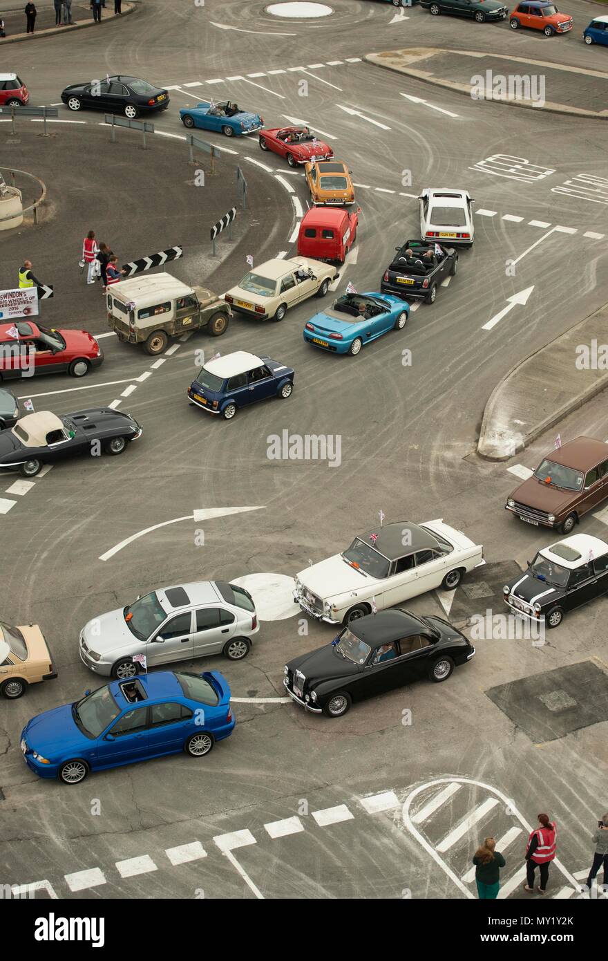 Collection of 60 classic cars parade around the Magic Roundabout ...
