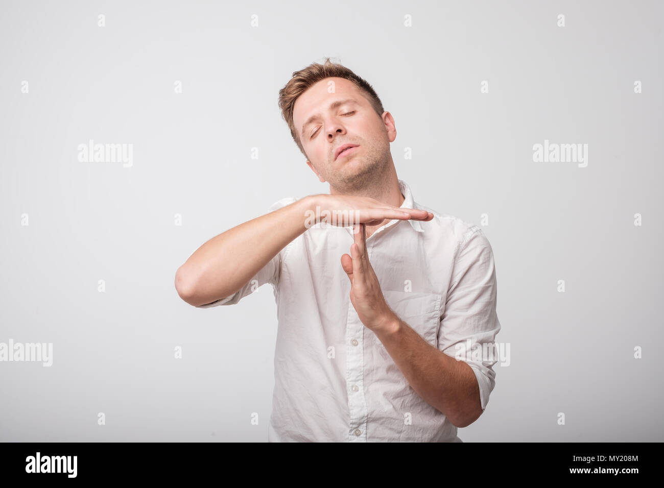 Young caucasian man tired and bored, making a timeout gesture Stock ...