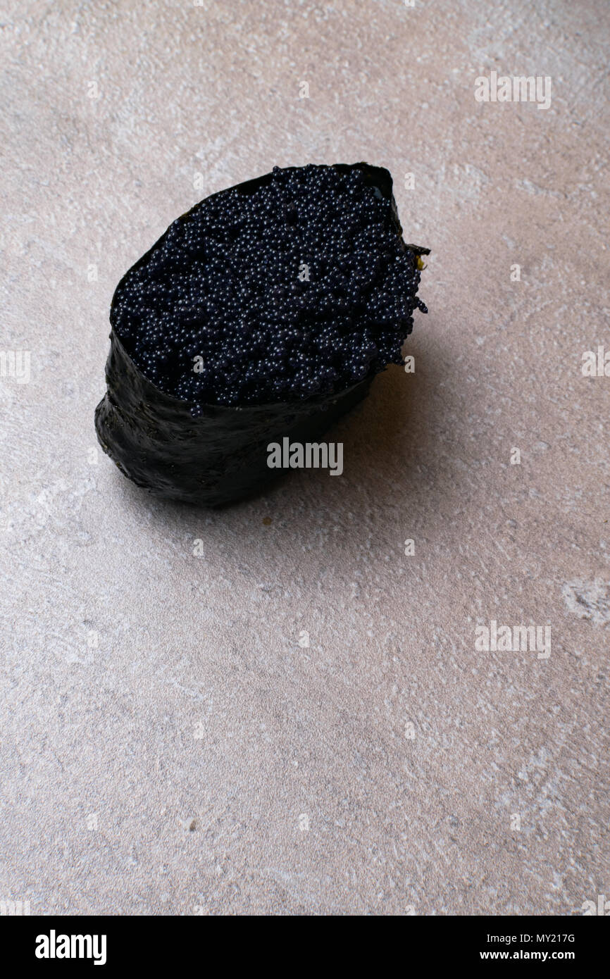 Black Tobiko flying fish roe Gunkan Maki Sushi with Cucumber. Isolated ...