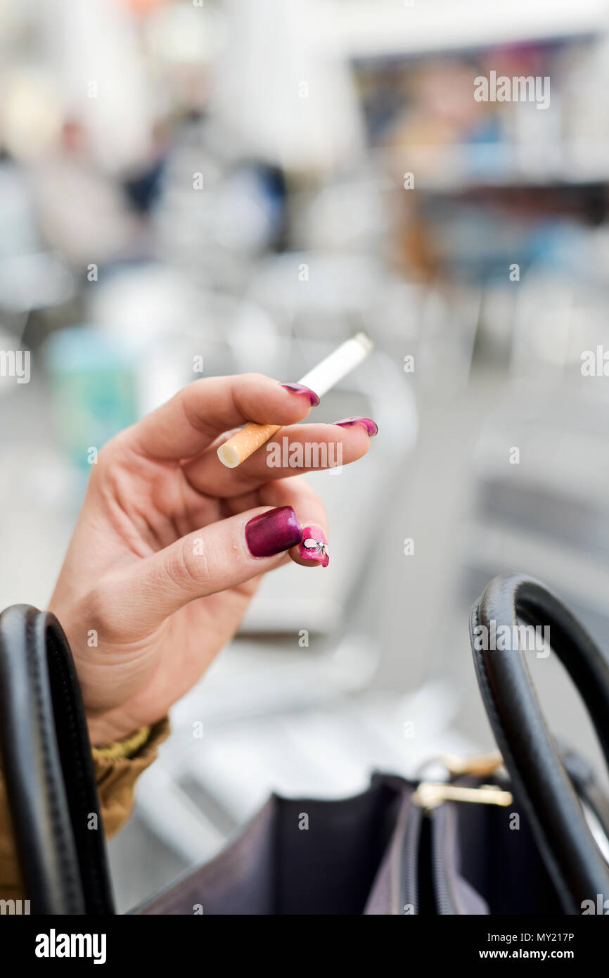 closeup of a young caucasian woman, with her fingernails painted purple ...