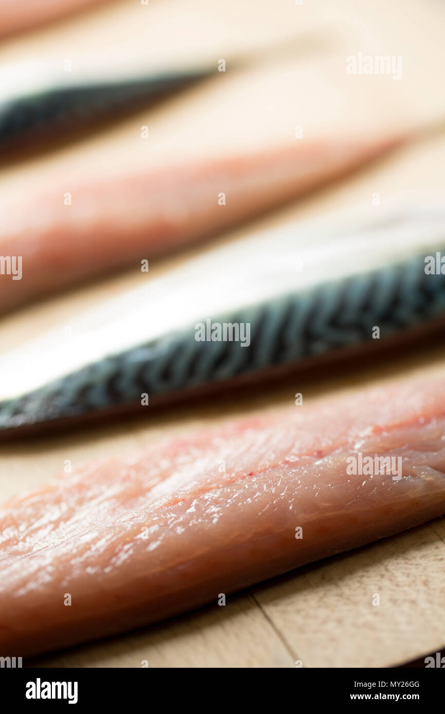 Raw mackerel fillets on a wooden chopping board from mackerel caught ...
