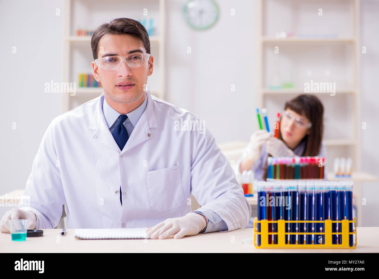 Two chemists working in lab experimenting Stock Photo - Alamy