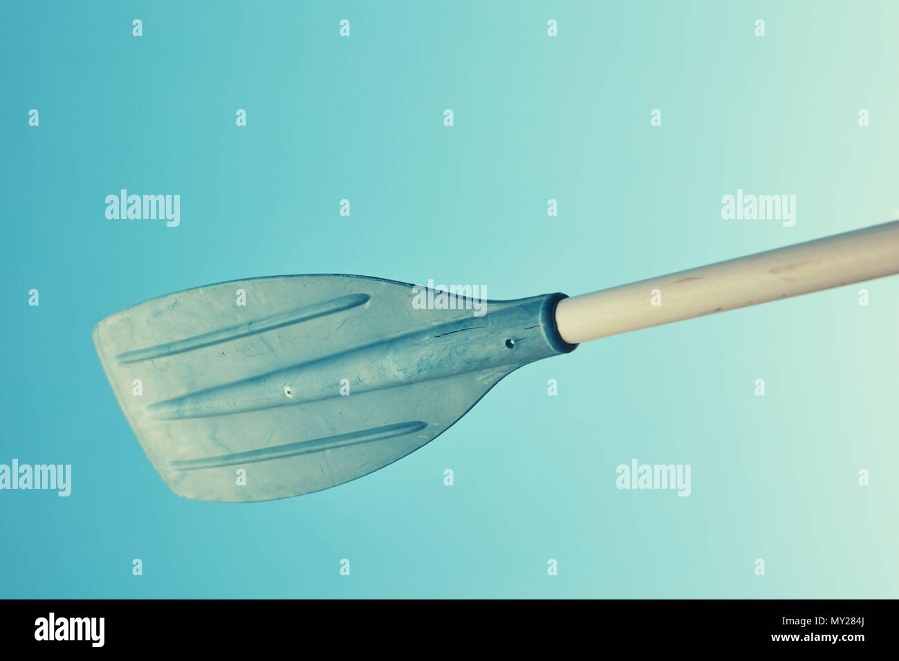 Blue oar rowing on blue background. Business effort, progress, contest ...