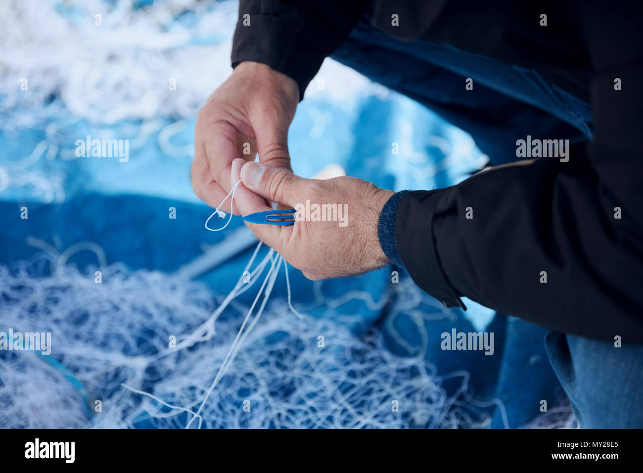 Repairing fixing net hi-res stock photography and images - Alamy