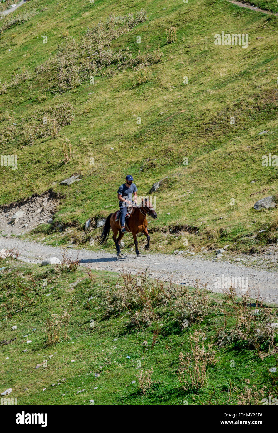 Ushguli, Georgia - September 6, 2017: Man galloping with horse on the ...