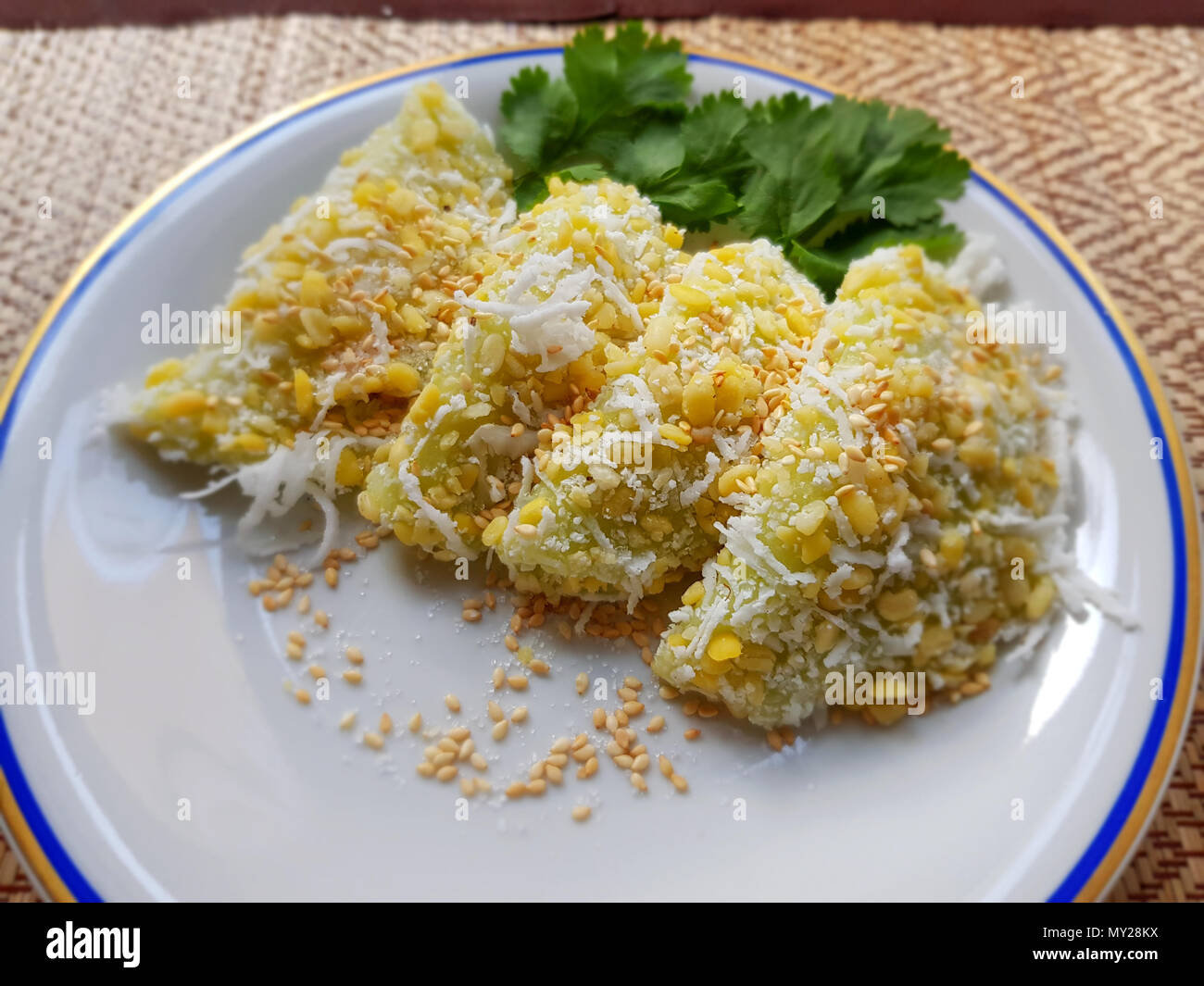 Thai sweet dessert, mung bean rice-crepe and coconut in white plate ...