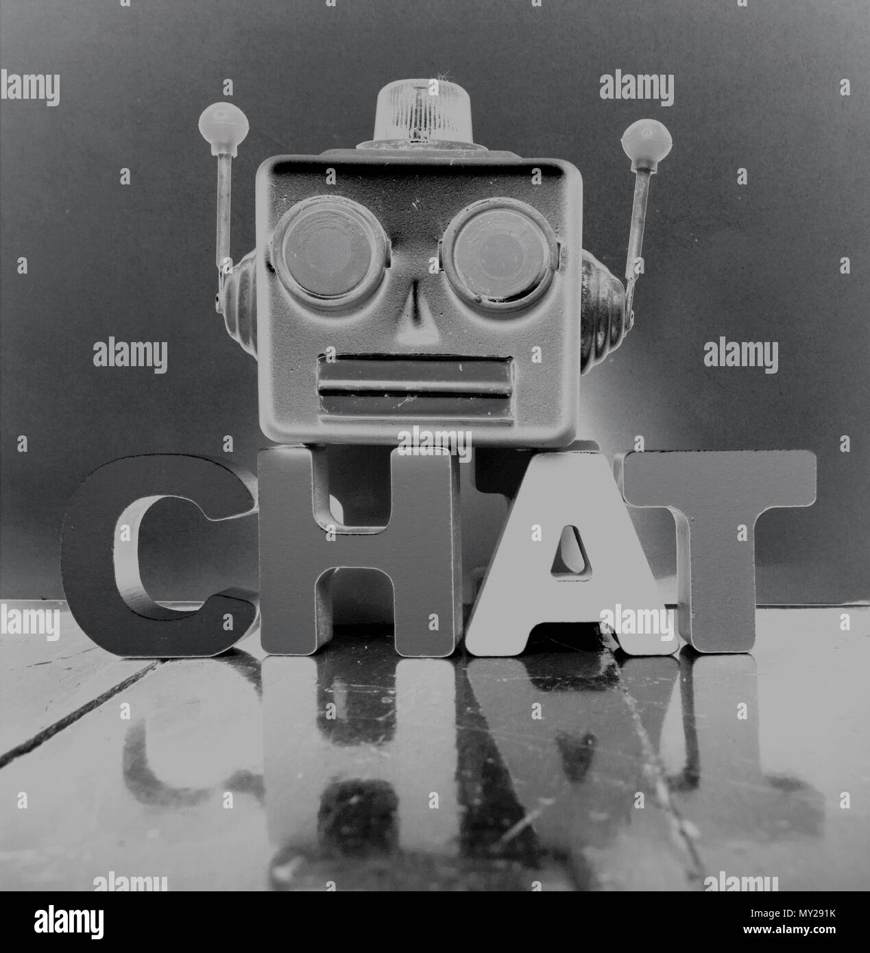 robot talking head in monochrome with the word CHAT on a wooden floor ...