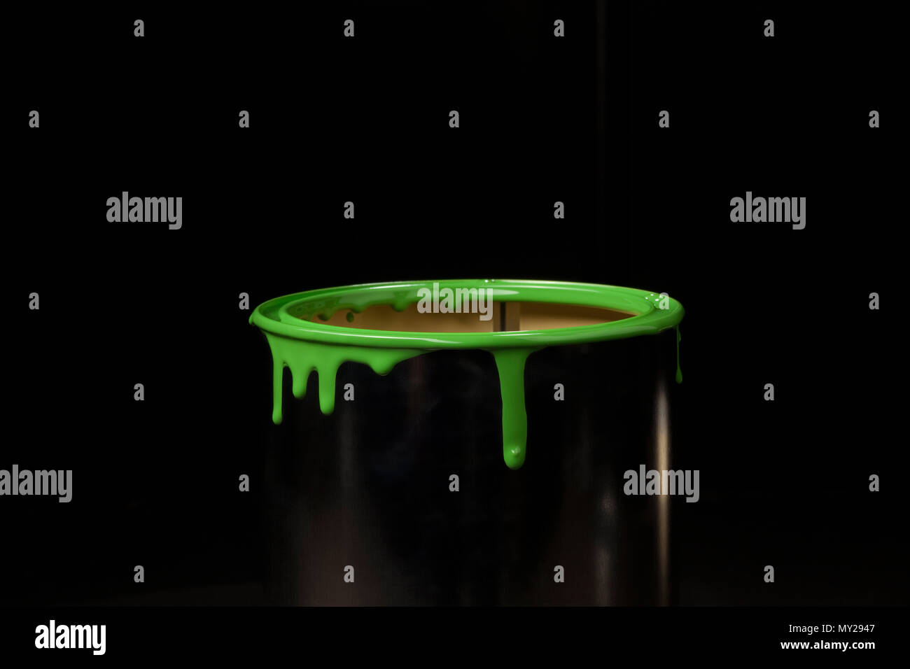 Colorful paint leaking down on wall of metal bucket. Isolated over ...