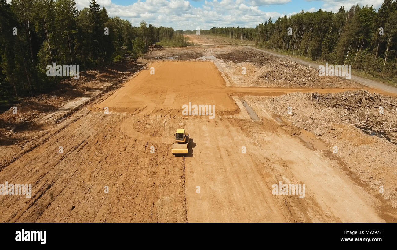 Construction of a new road in the forest area. Aerial view construction ...
