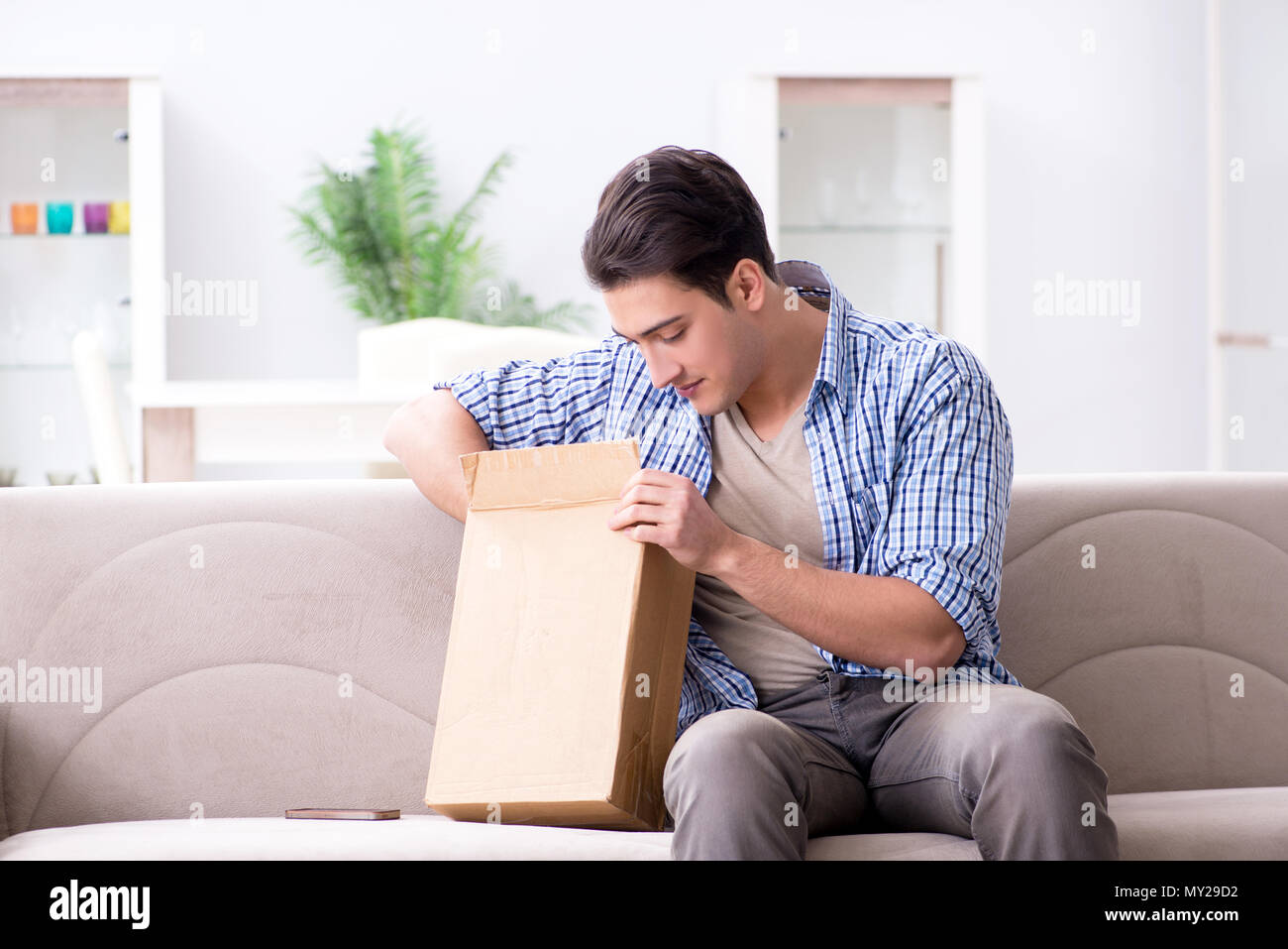 Man receiving empty parcel with stolen goods Stock Photo - Alamy
