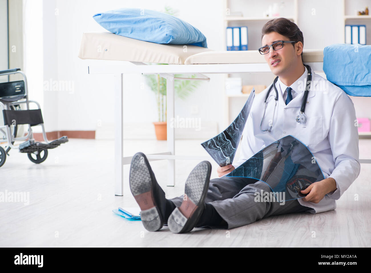 Doctor sitting on the floor in hospital Stock Photo - Alamy