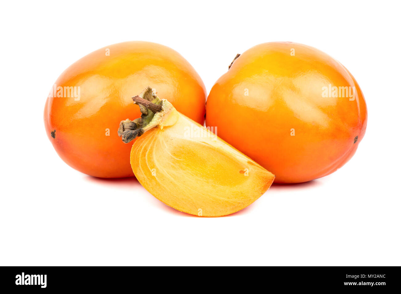 Two fruits persimmon with slice on a white background Stock Photo - Alamy
