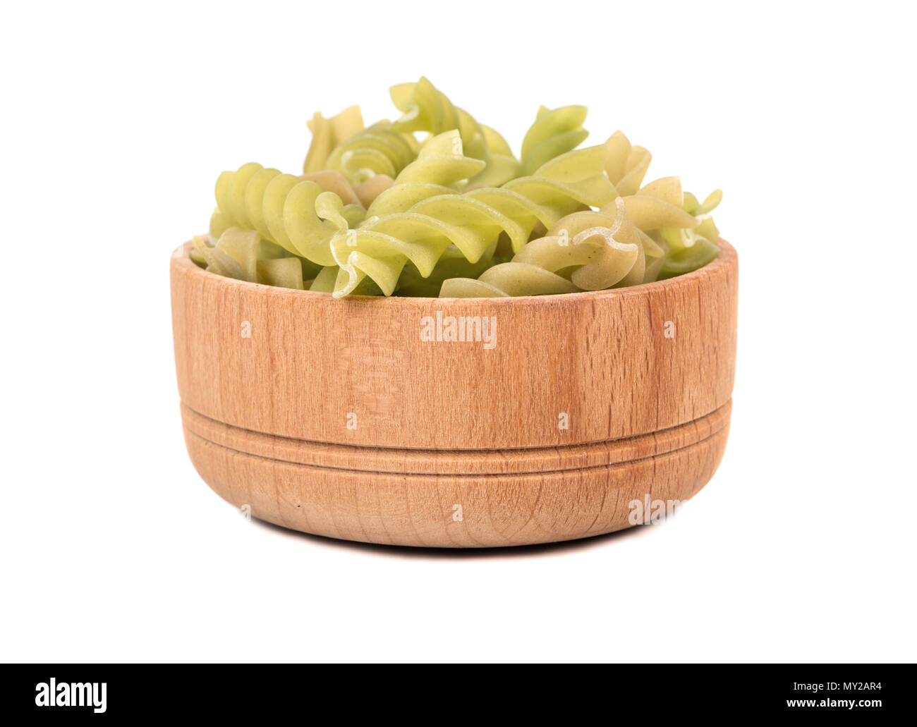 Green pasta fusilli in a small bowl on a white background Stock Photo ...