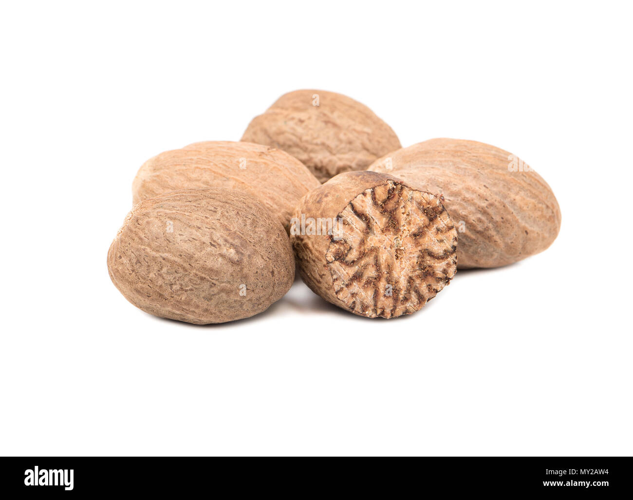 Dry nutmeg with half isolated on white background Stock Photo - Alamy