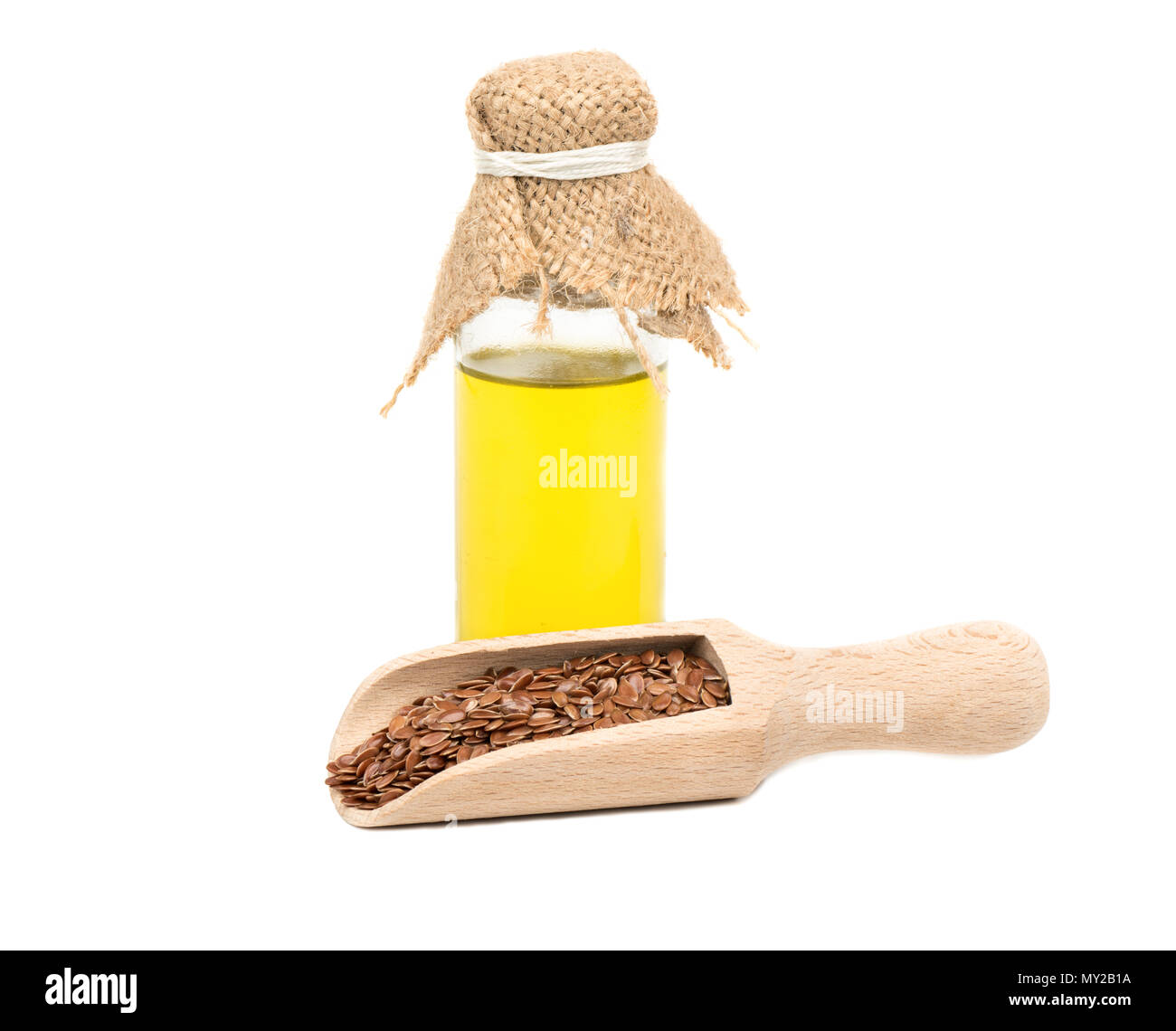 Flax oil in a bottle with a scoop of seed on white background Stock ...