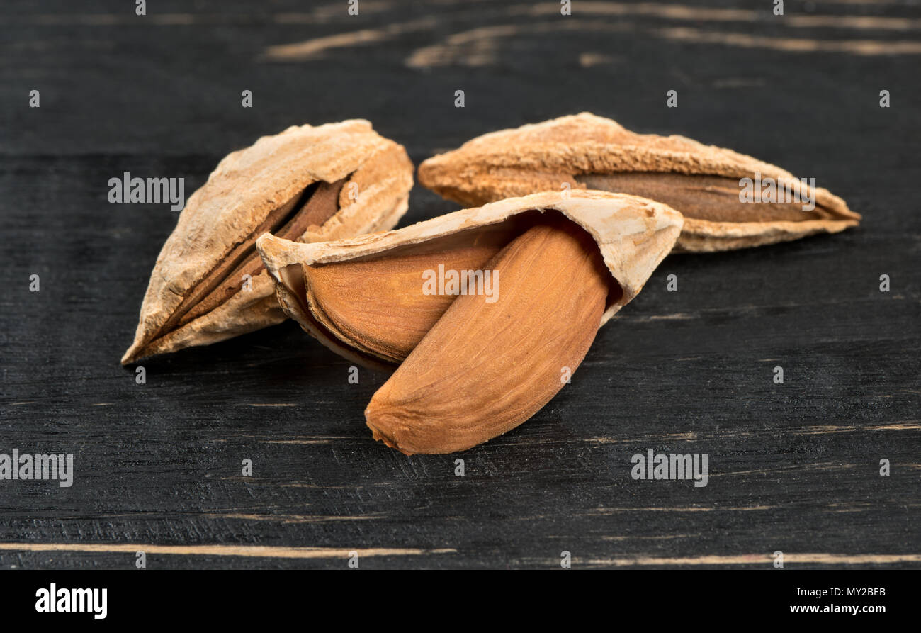 Wild uzbek inshell almonds on wooden background Stock Photo - Alamy