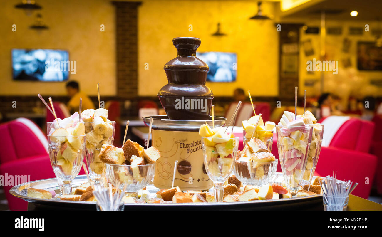Chocolate fountain with fruits and sweets Stock Photo - Alamy