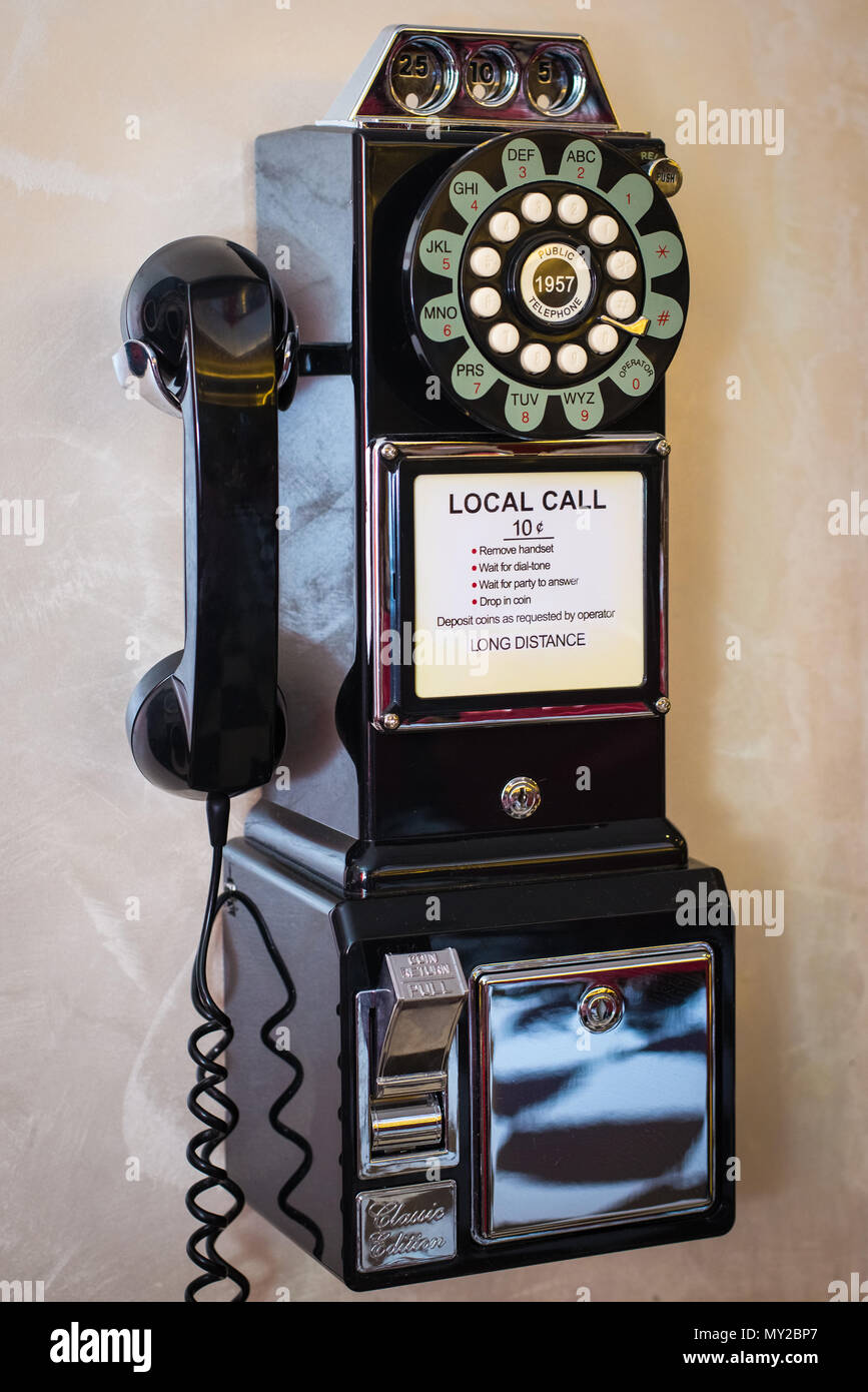 The old phone hangs on the wall Stock Photo - Alamy
