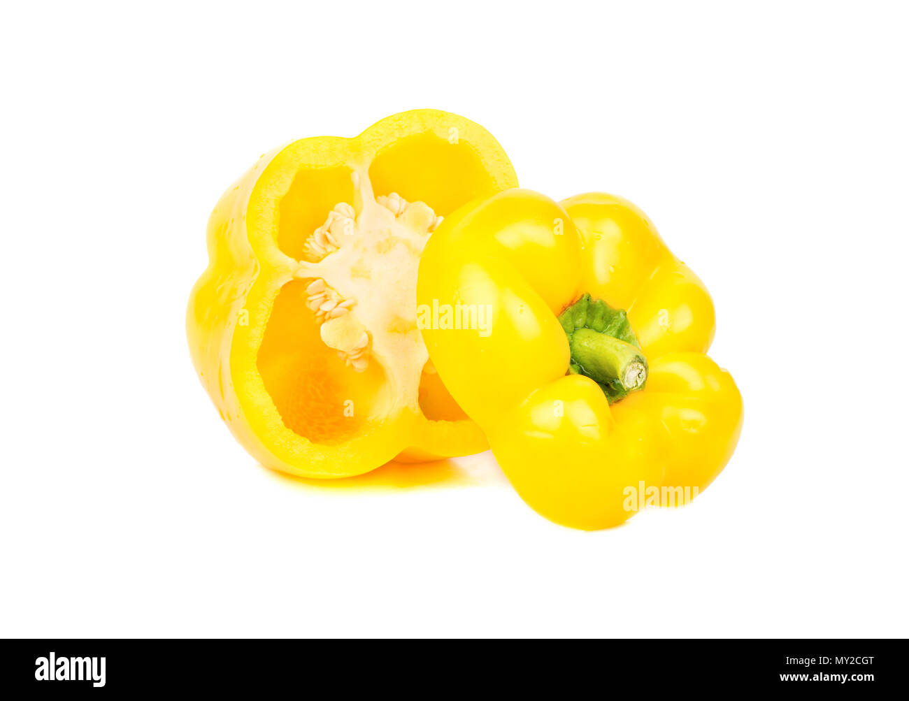 Fresh yellow pepper cut in half on white background Stock Photo - Alamy