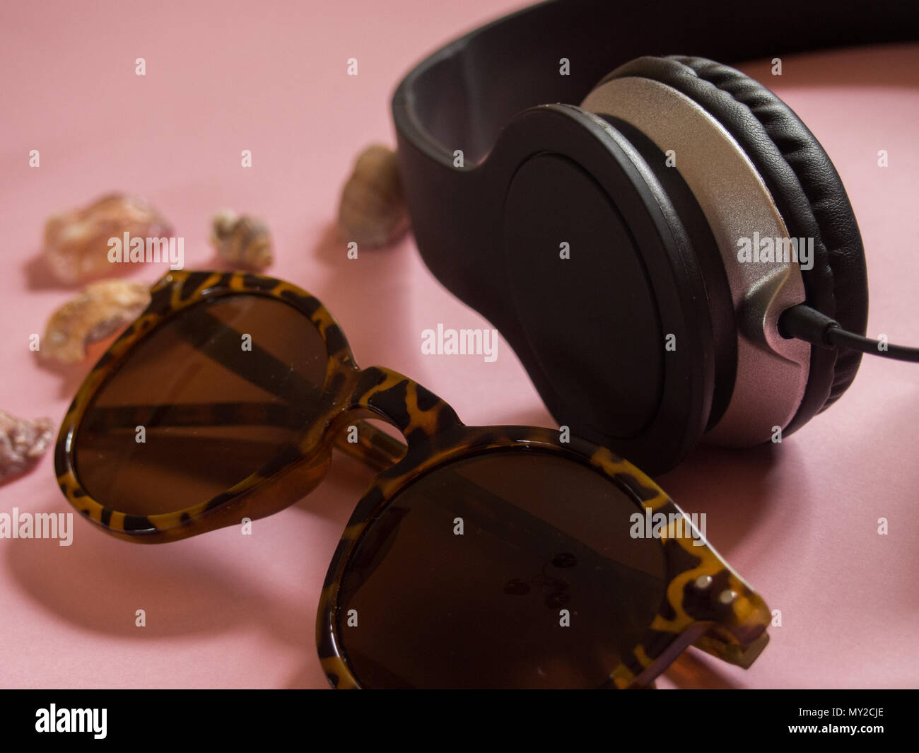 Sunglasses, earphones and seashells on pink background - Summer concept ...