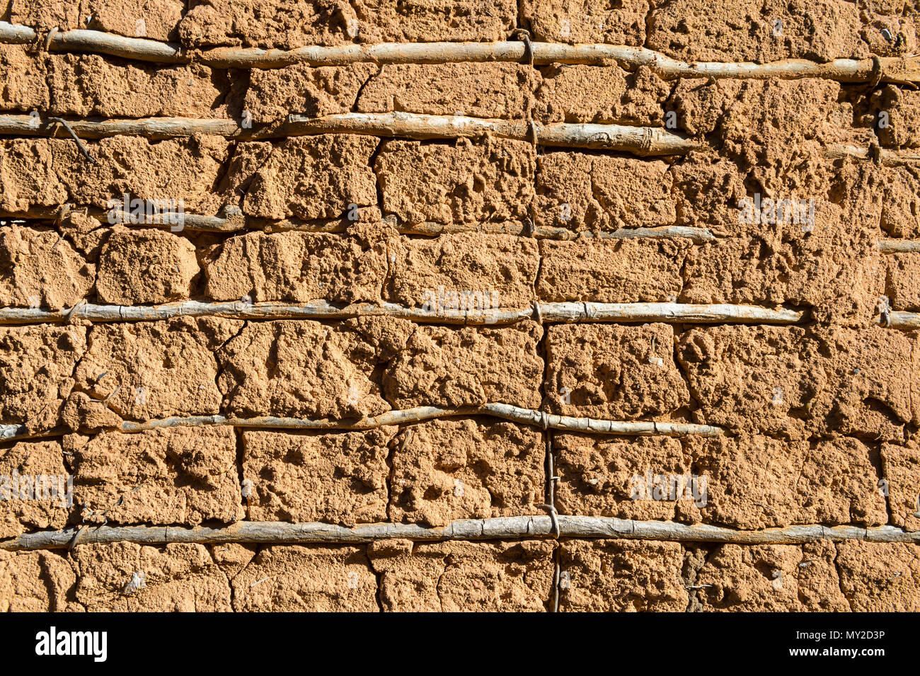 Background of traditional mud brick wall architecture layered with ...