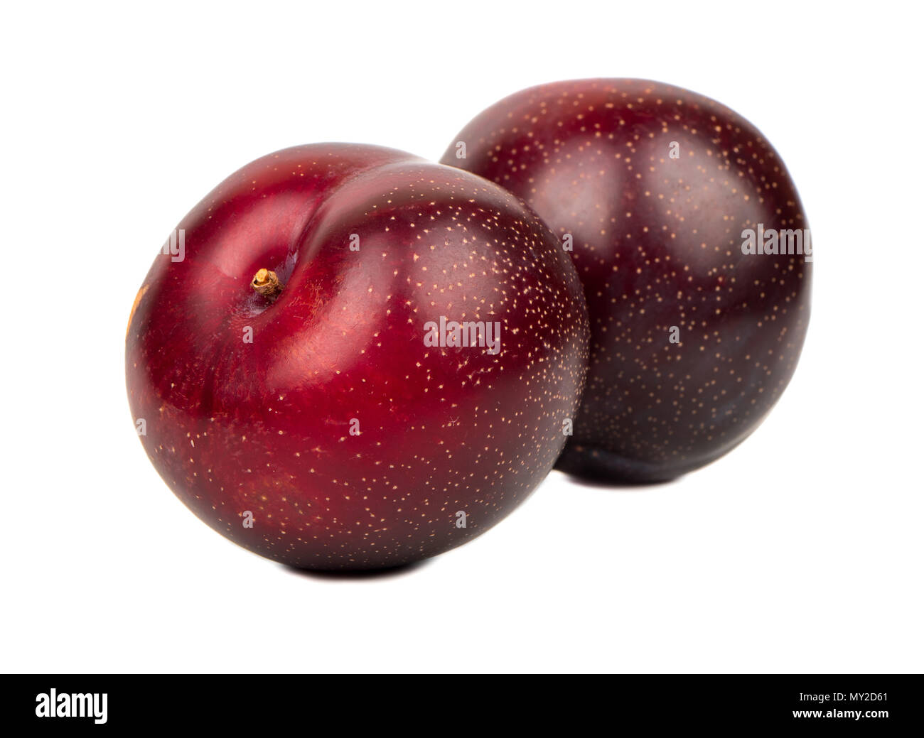 Two ripe large red plums isolated on white background Stock Photo - Alamy