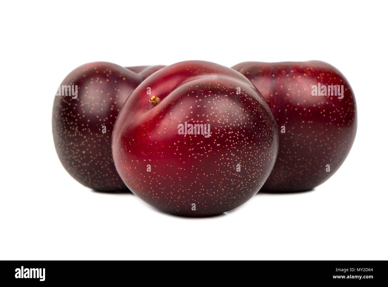 Three ripe large red plums on white background Stock Photo - Alamy