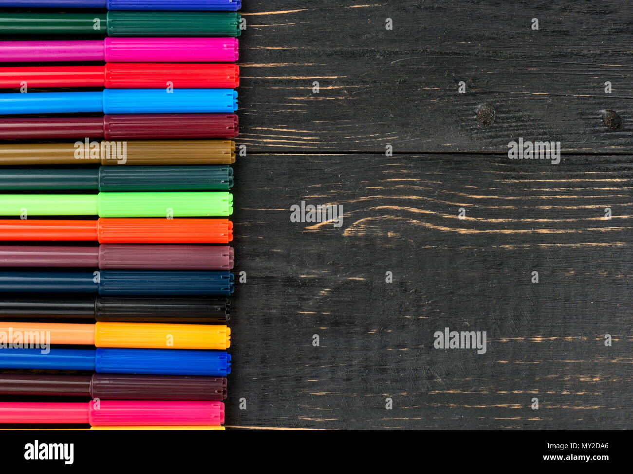 Lot of colorful markers on wooden background, top view Stock Photo - Alamy