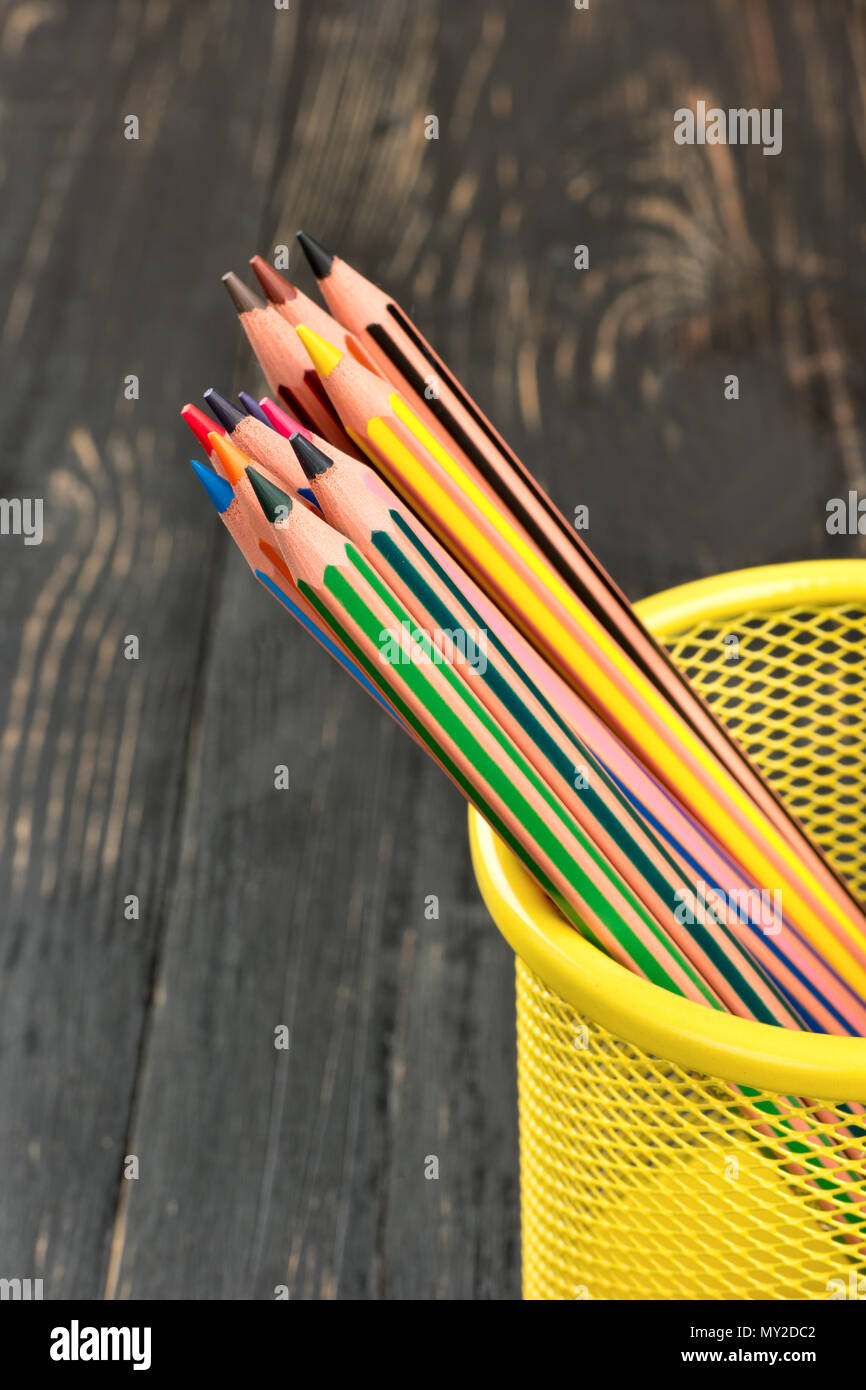 Colored pencils in a metal basket on table close-up Stock Photo - Alamy