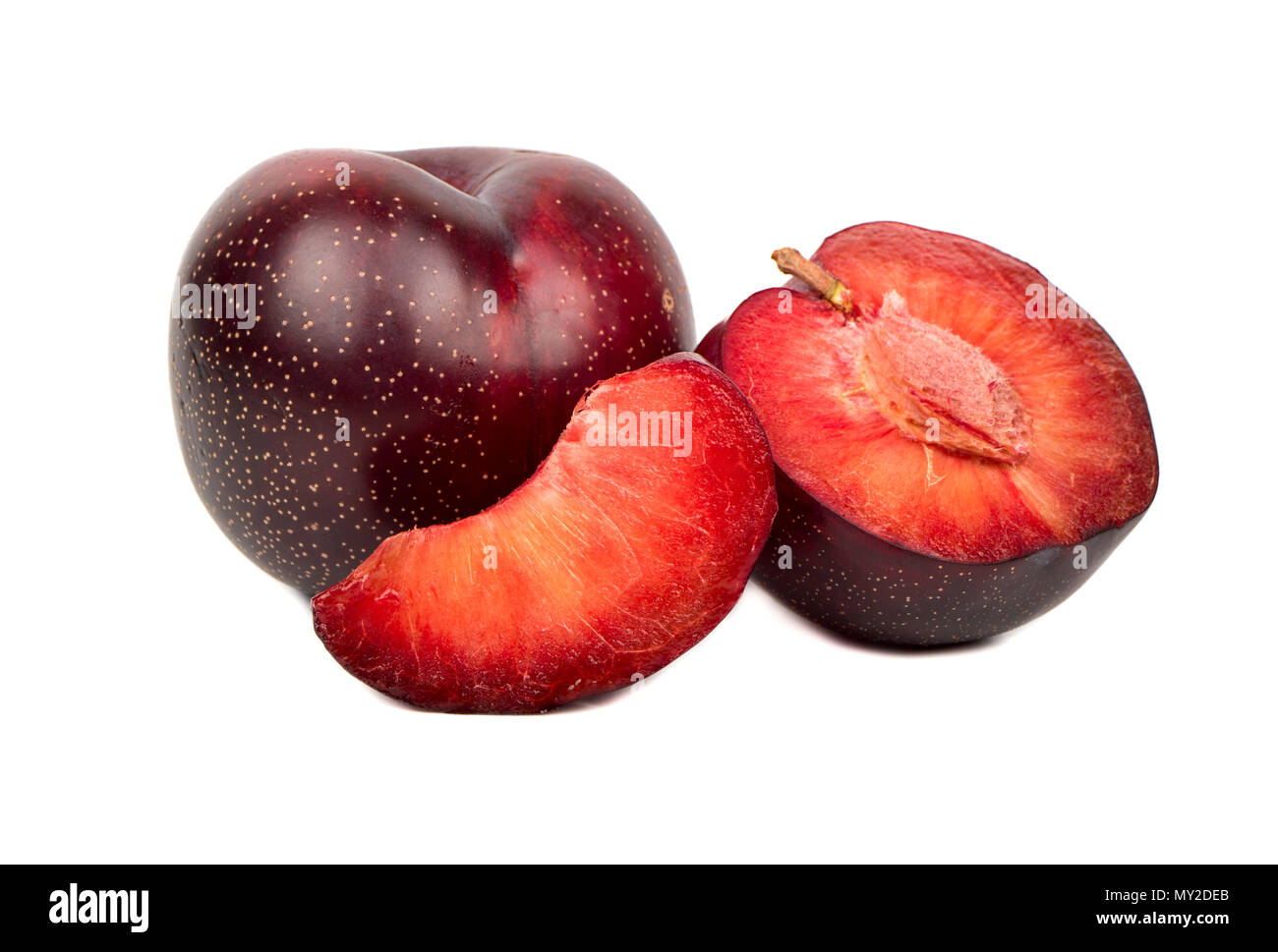 Ripe red plum with half and slice on white background Stock Photo - Alamy