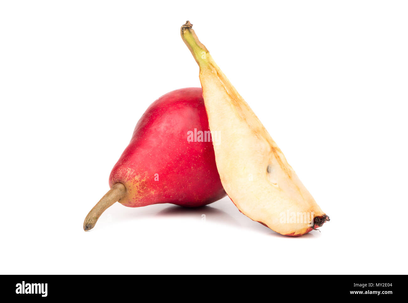 Ripe red pear with a slice isolated on white background Stock Photo - Alamy