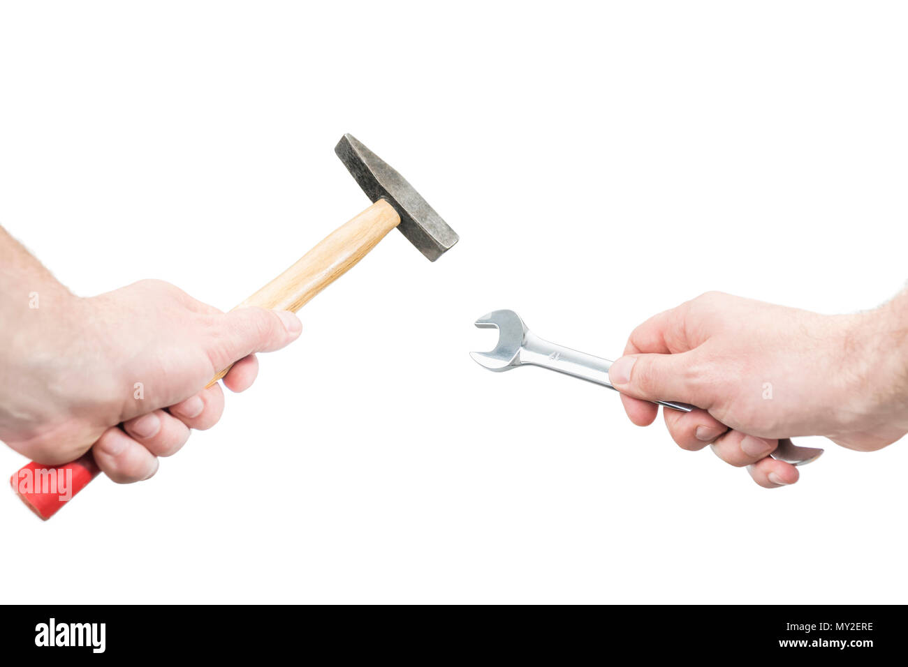 Male hands holding a hammer and a wrench, close-up, isolated on a white ...