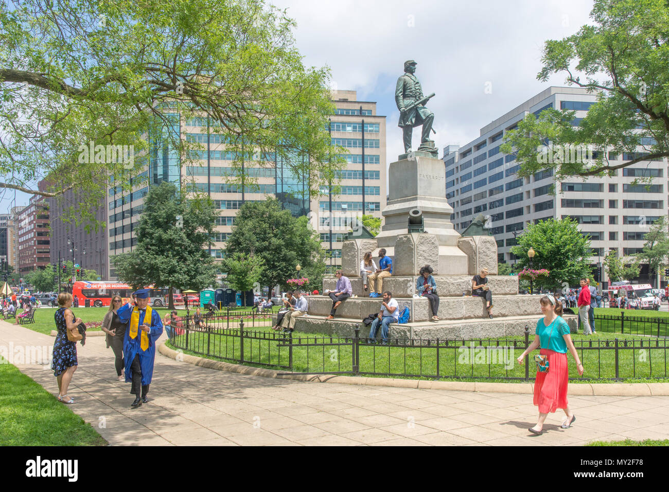 Office workers enjoy their lunch in Farragut Square, an urban park in downtown Washington, DC ...