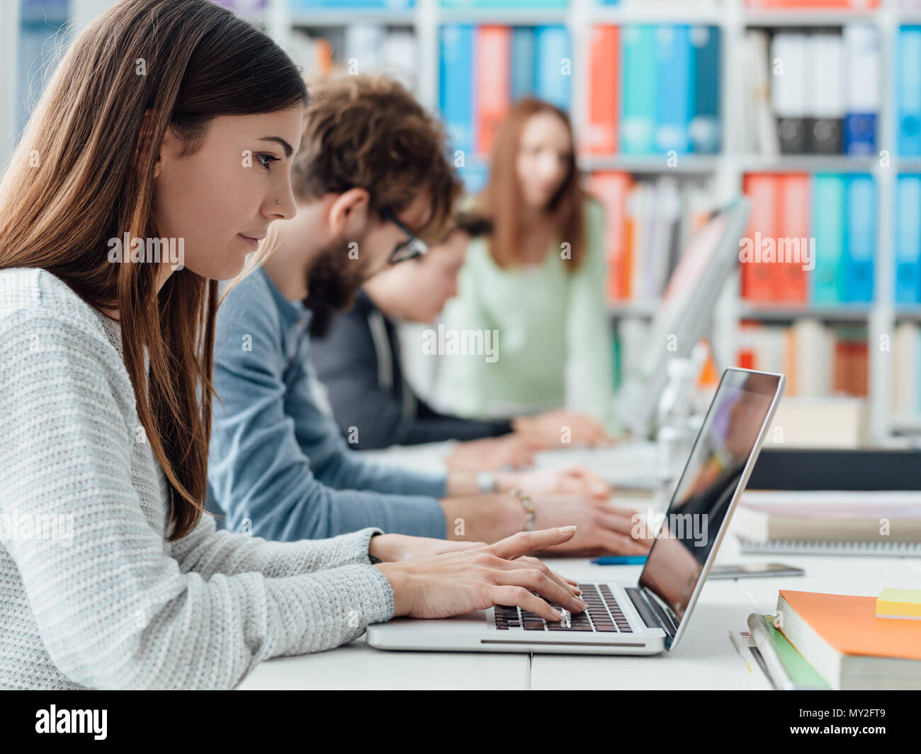 Young office workers and students at the coworking space, they are ...