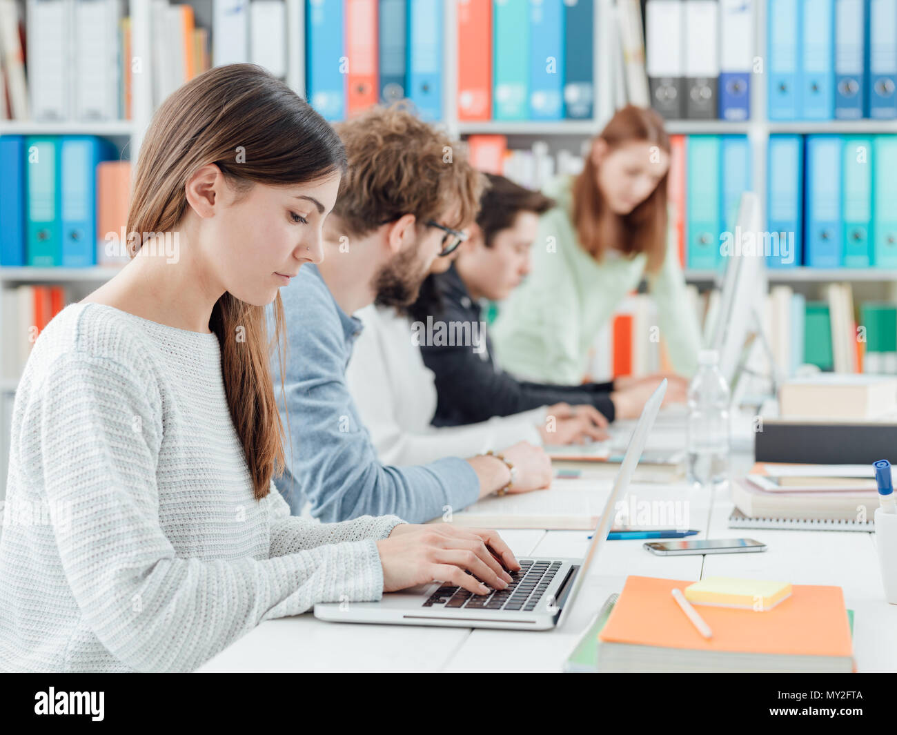 Young office workers and students at the coworking space, they are ...