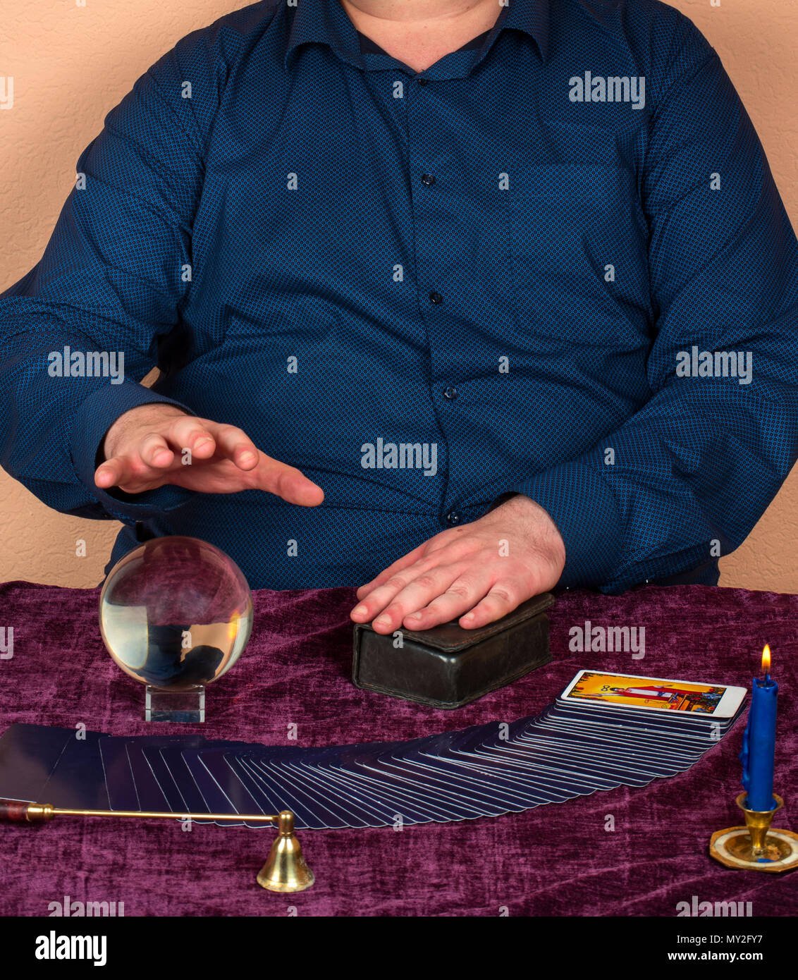 Full man guessing on cards of Taro and the magic ball Stock Photo - Alamy