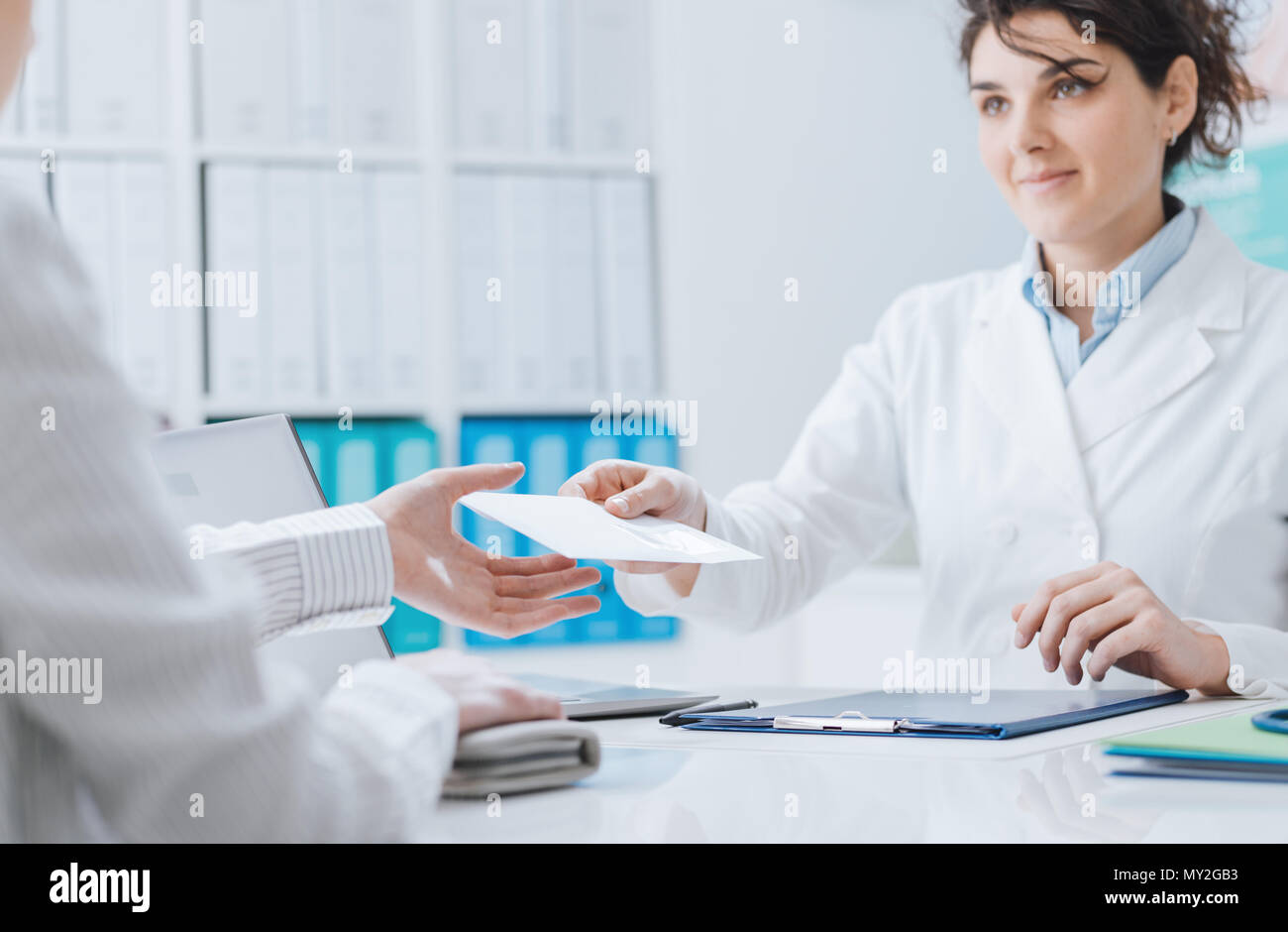 Doctor and patient meeting in the office, the doctor is giving a ...