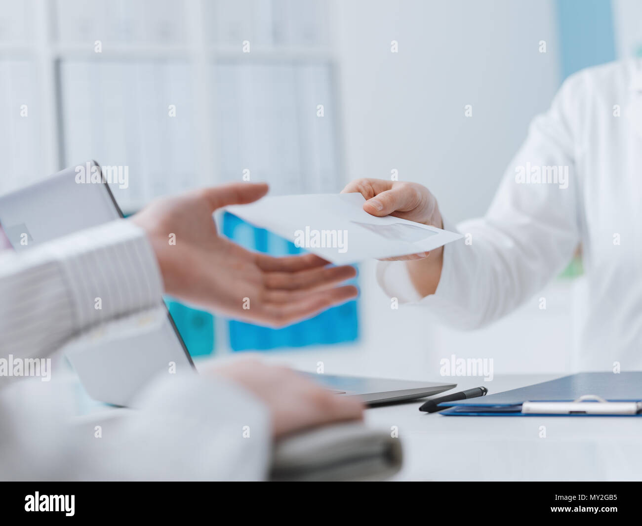 Doctor and patient meeting in the office, the doctor is giving a ...