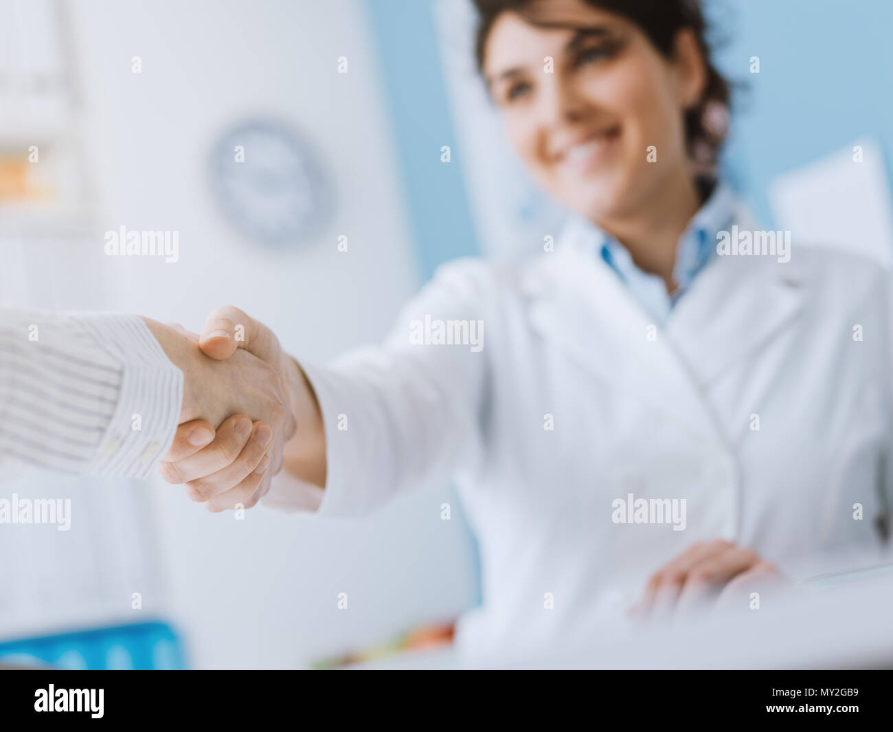 Female doctor welcoming clinic hi-res stock photography and images - Alamy