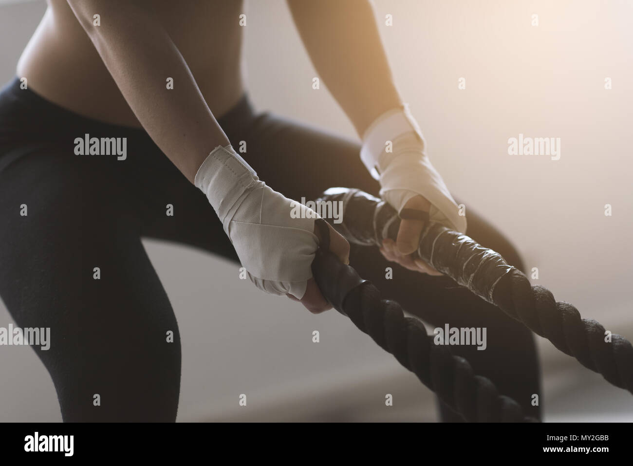 Female athlete gripping battle rope hi-res stock photography and images ...