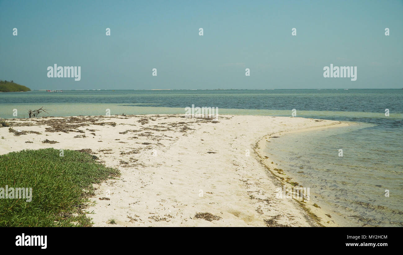 Tropical island with white sandy beach in blue lagoon. Tondol white ...