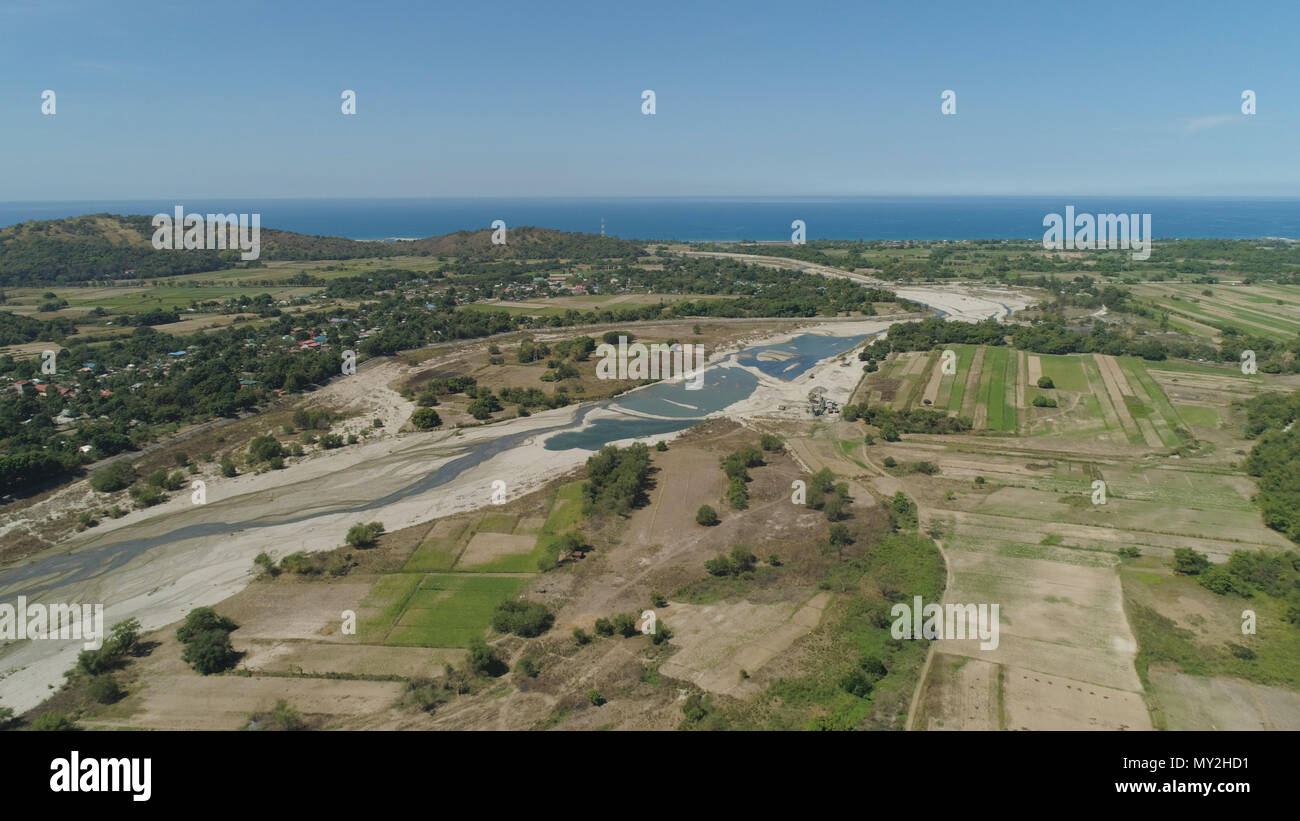 Dried up river bed among the farm fields in the mountainous province ...