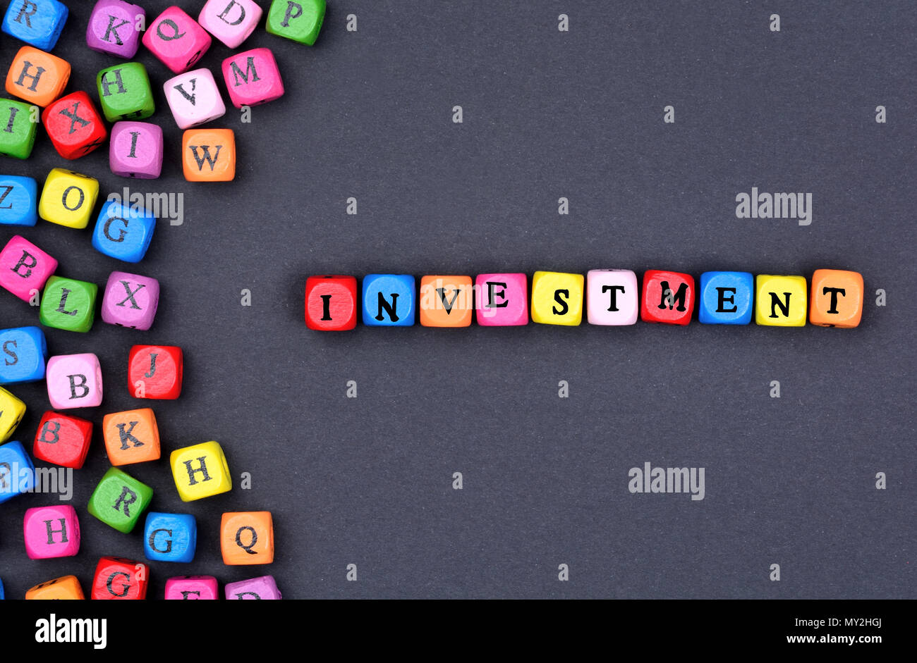Investment word on black background close up Stock Photo - Alamy