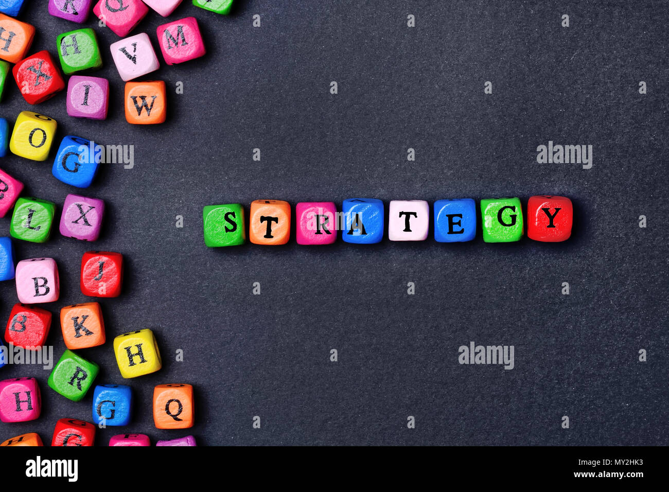 Strategy word on black background close up Stock Photo - Alamy