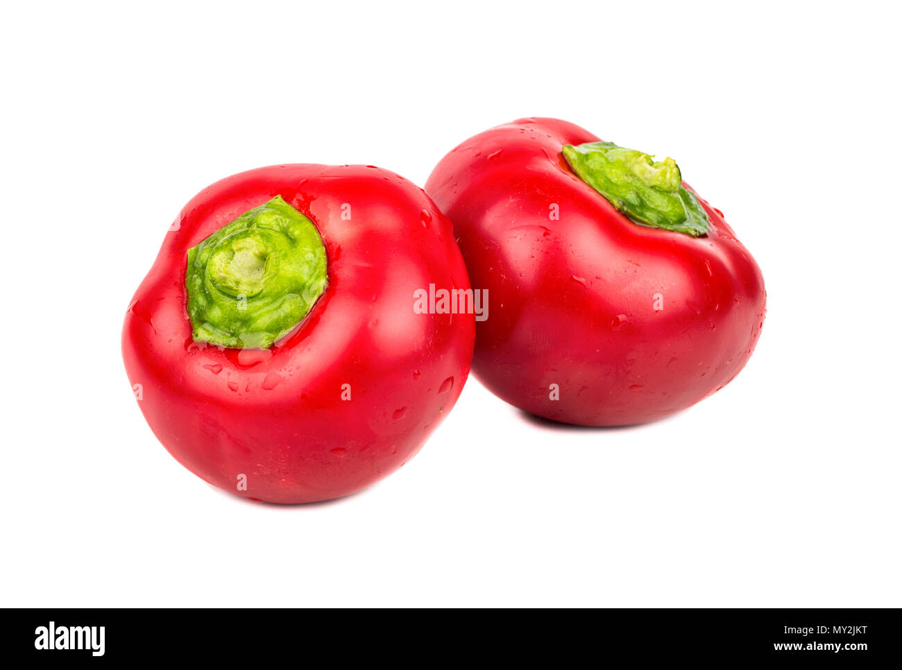 Two small red peppers on a white background Stock Photo - Alamy