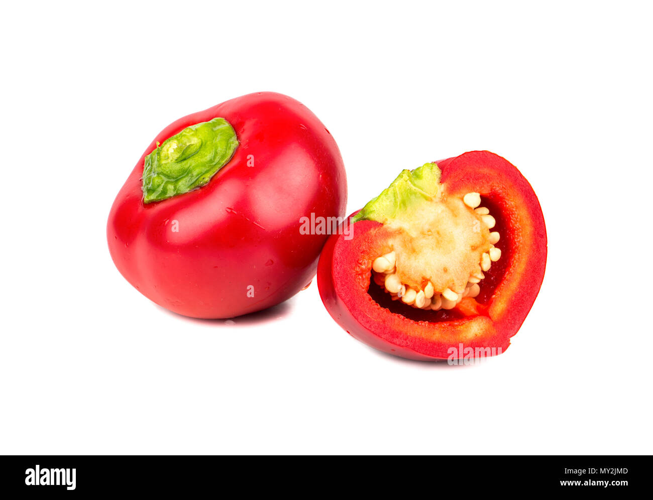 Small red pepper with half on a white background Stock Photo - Alamy