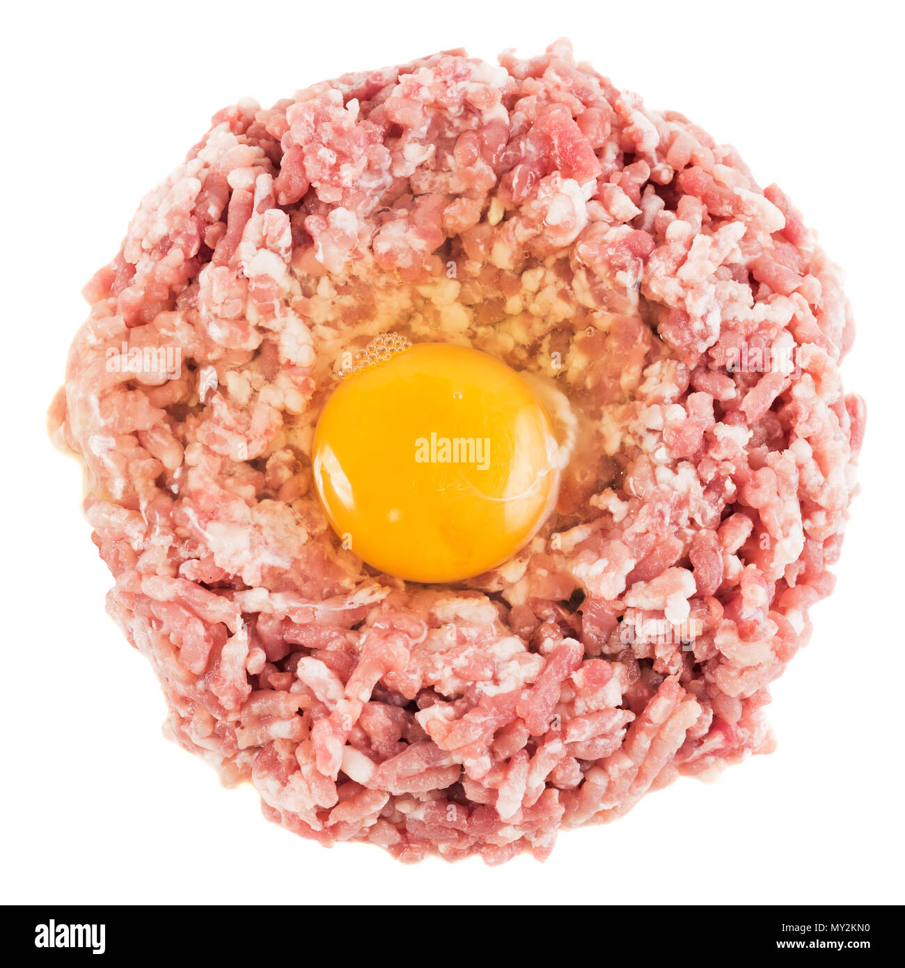 Ground cutlet or raw hamburger with chicken egg yolk isolated on white ...