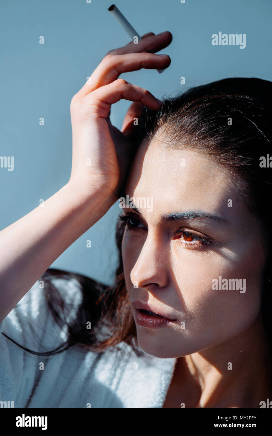 Portrait of young beautiful woman with natural makeup holding a ...